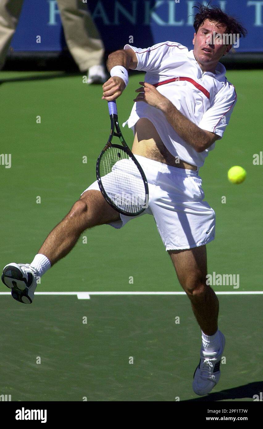 Vincent Spadea hits an overhand return to Nicolas Kiefer, of Germany ...