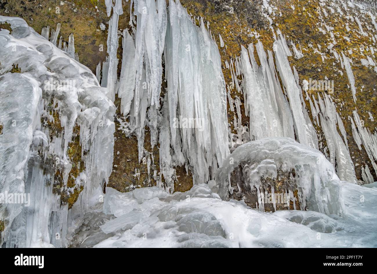Icy stalagmites created from the side of a mountain next to the ...