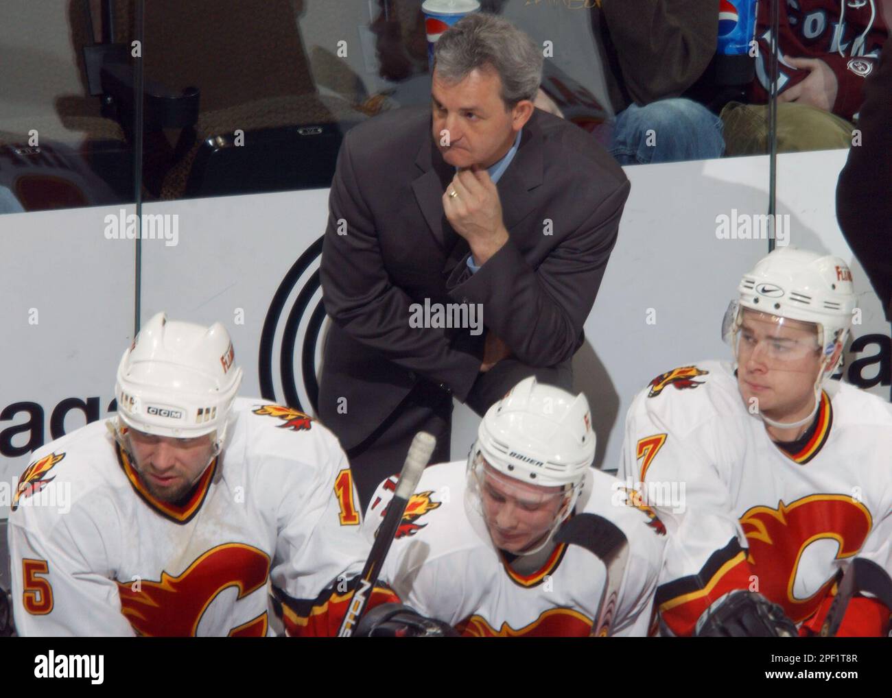 Calgary Flames coach Darryl Sutter, background, looks on with, from ...