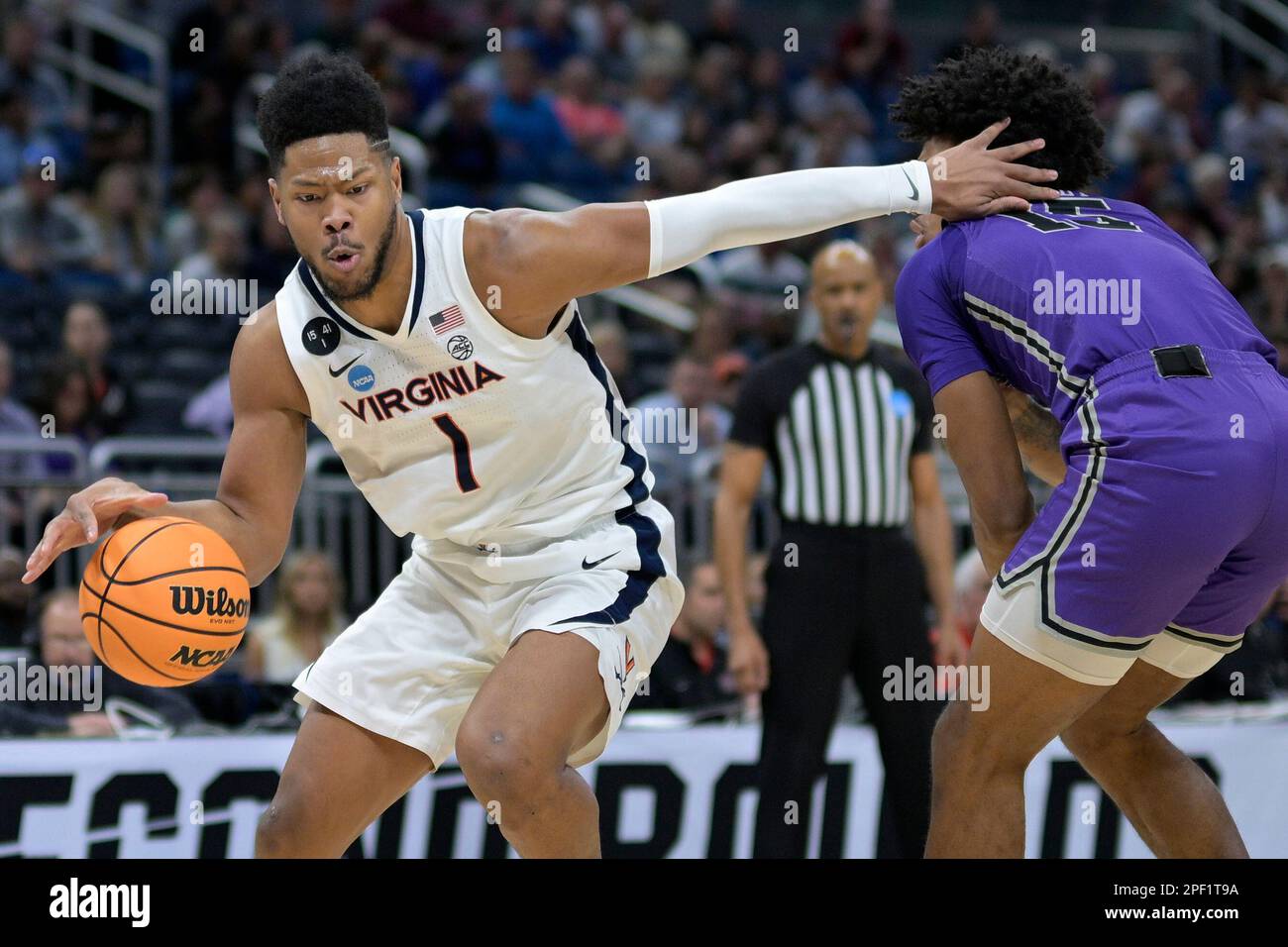 Virginia forward Jayden Gardner (1) drives past Furman forward Tyrese ...