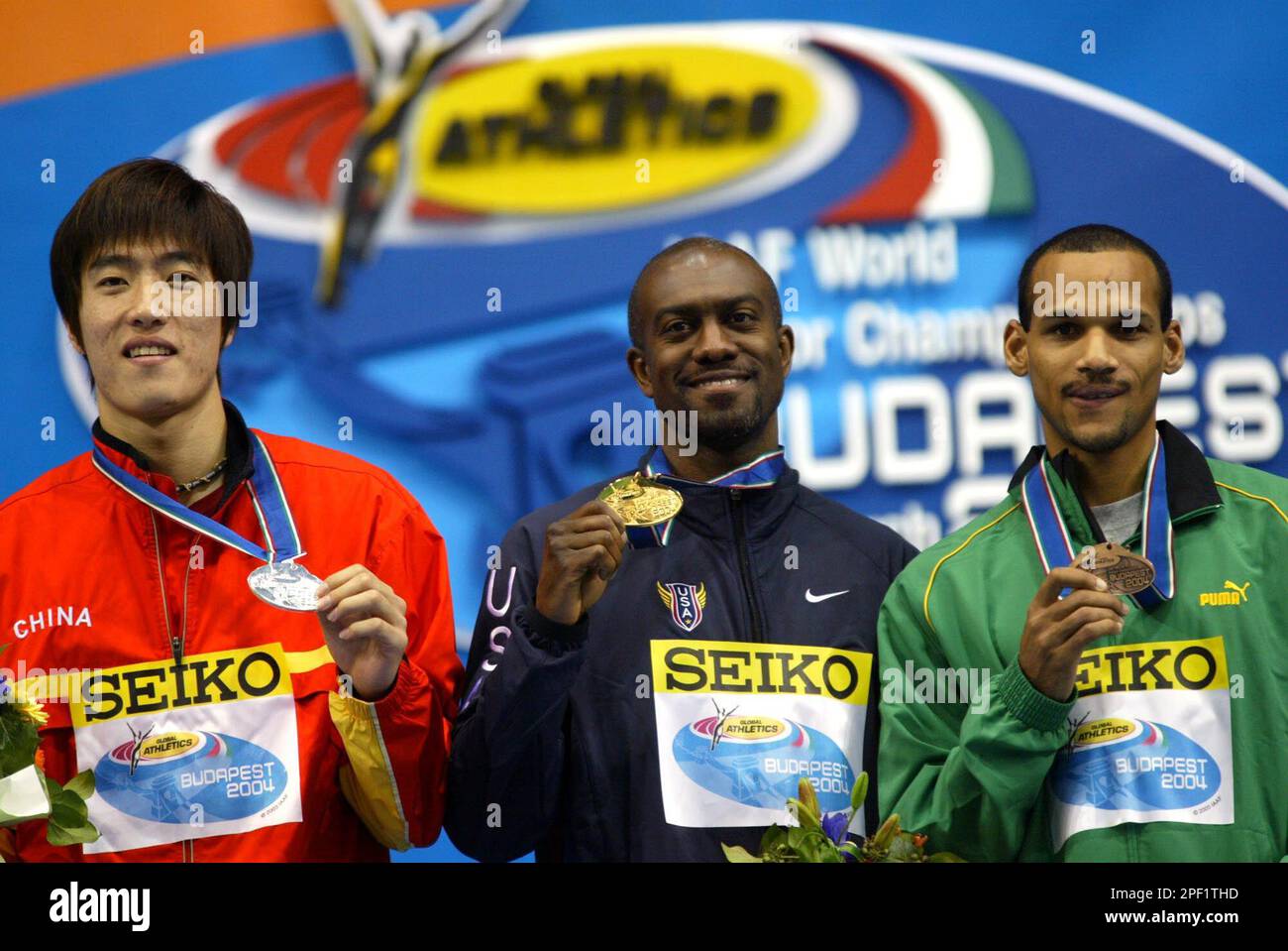 American 60m hurdles world champion Allen Johnson, centre, is flanked ...