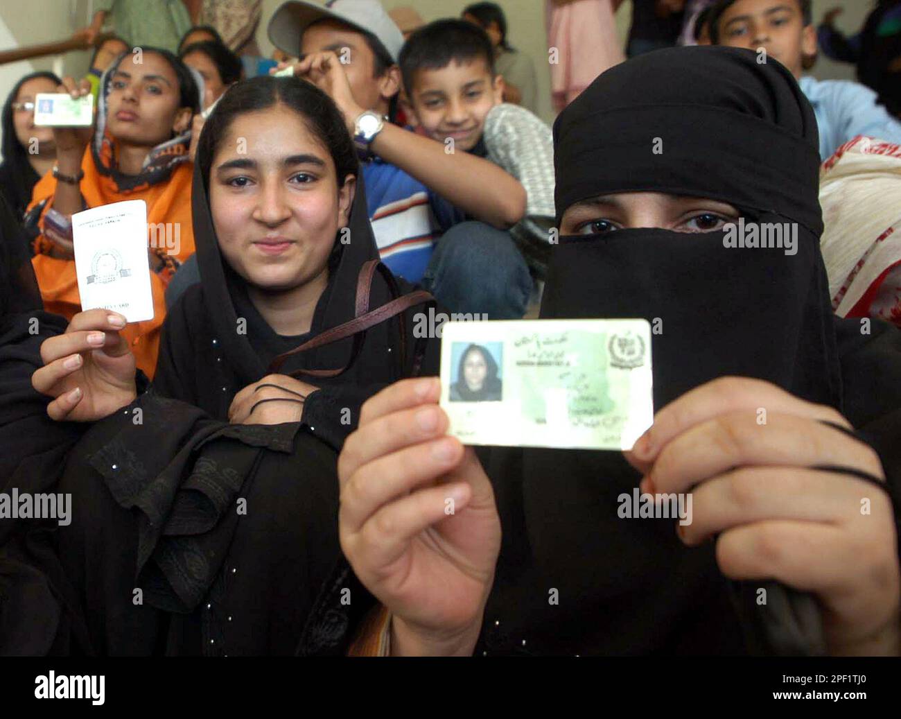 Pakistani girls show their National I. D cards as they gathered in ...