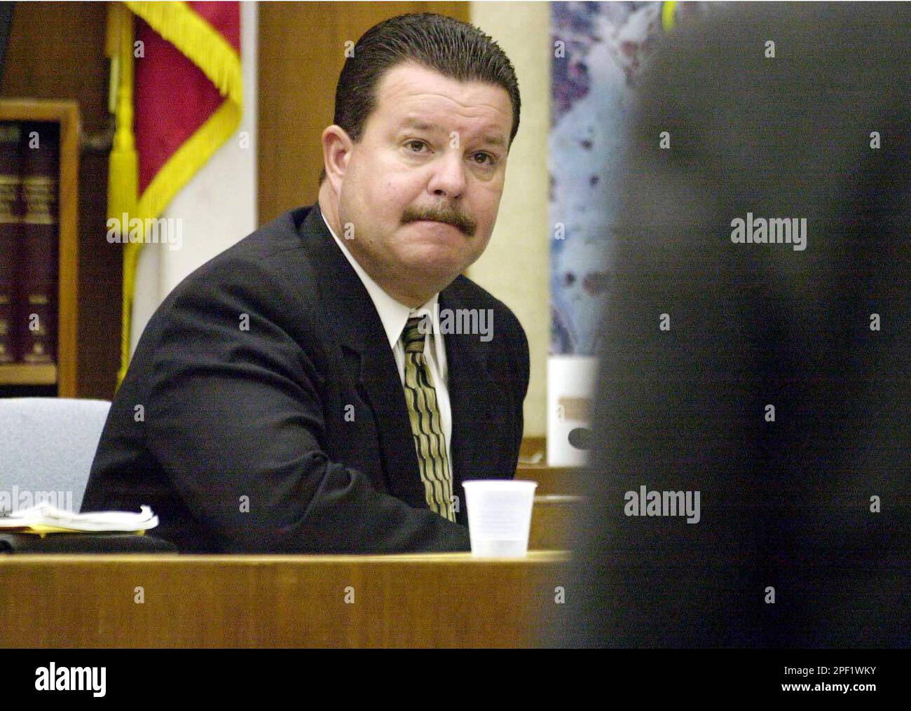 Escondido Police detective Dan Tulimero listens to a question while on ...