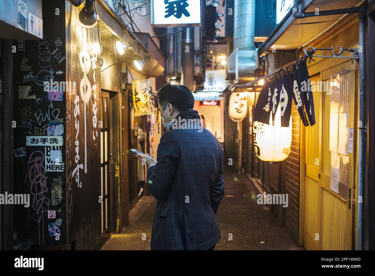 A typical Japanese salaryman (white-collar worker) standing outside one ...
