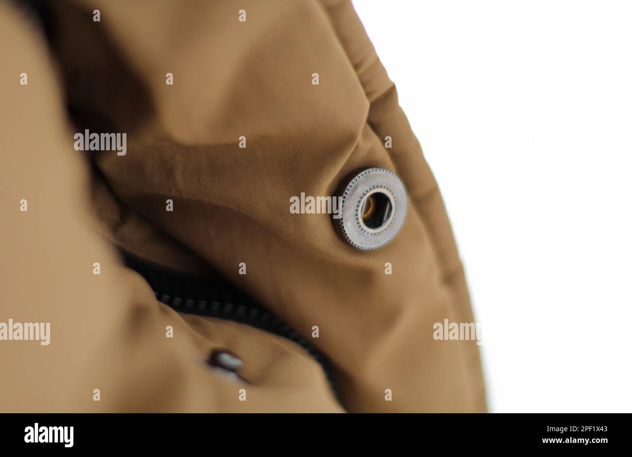 Copper metallic pressing button close up on brown winter jacket Stock ...