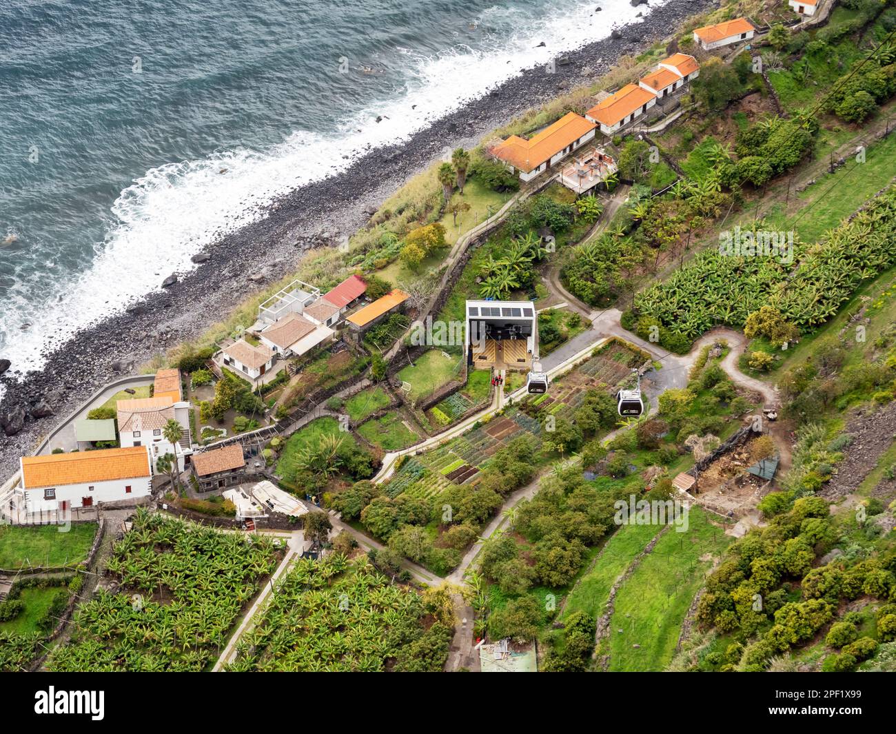 A cable car down the steep coastal cliffs to an organic farm at Faja ...