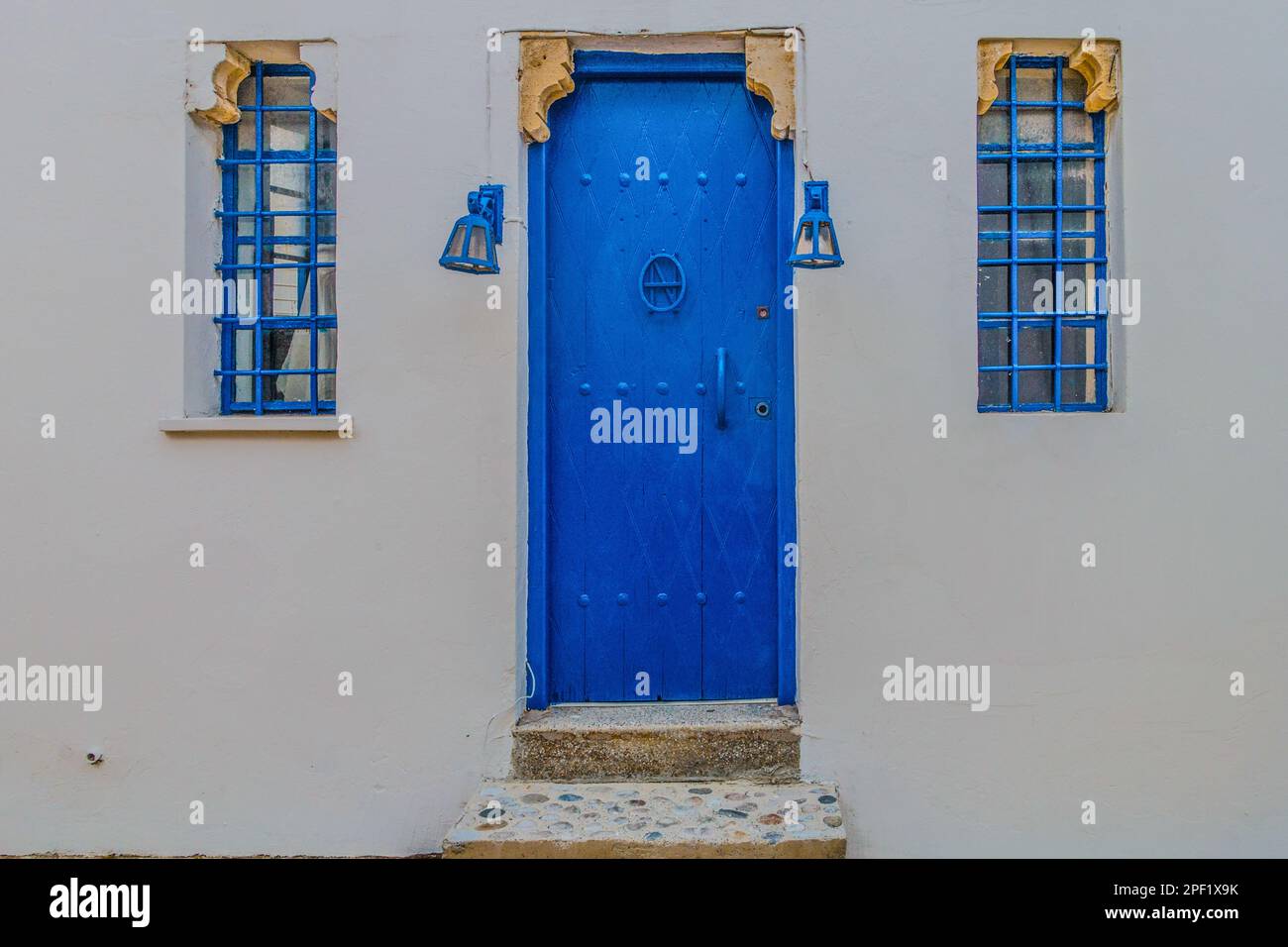 House with blue door and windows with grating. Kyrenia (Girne), Turkish ...