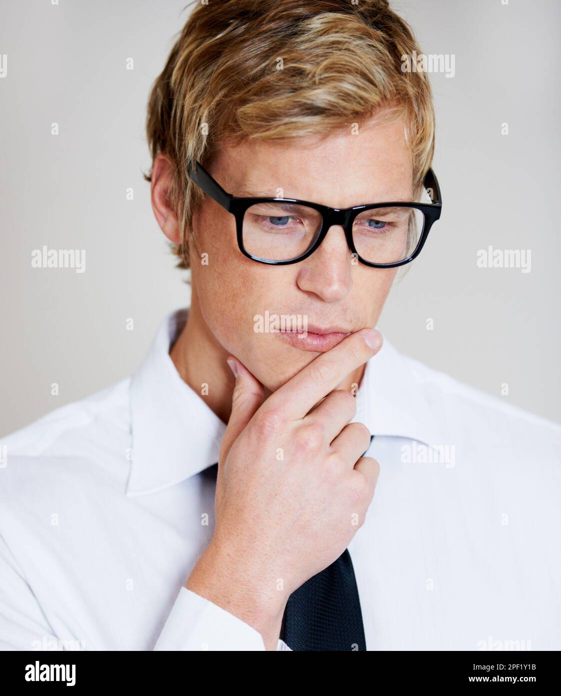 Thinking of some new ideas for his business. a young man standing and ...