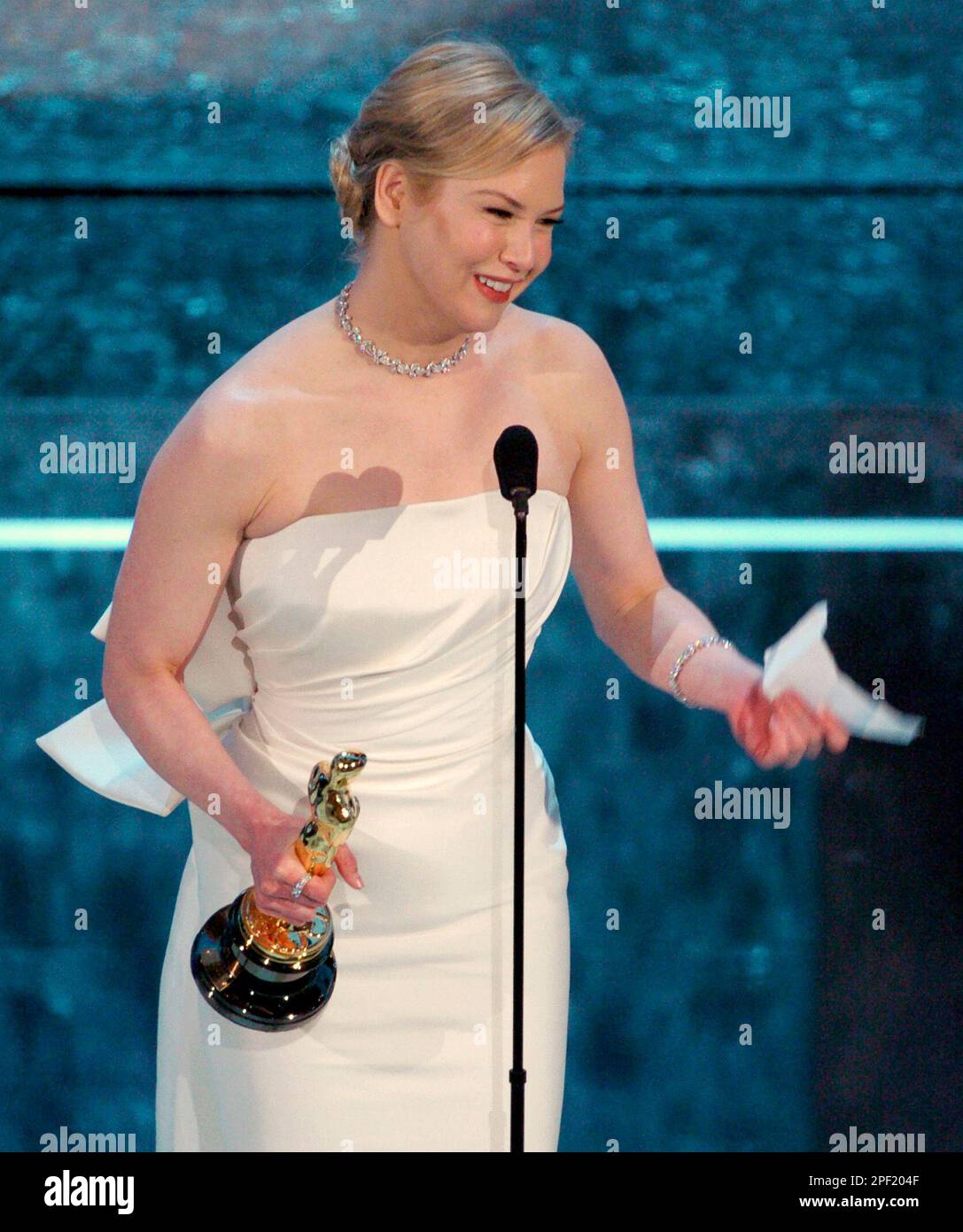 Actress Renee Zellweger accepts the Oscar for best supporting actress ...