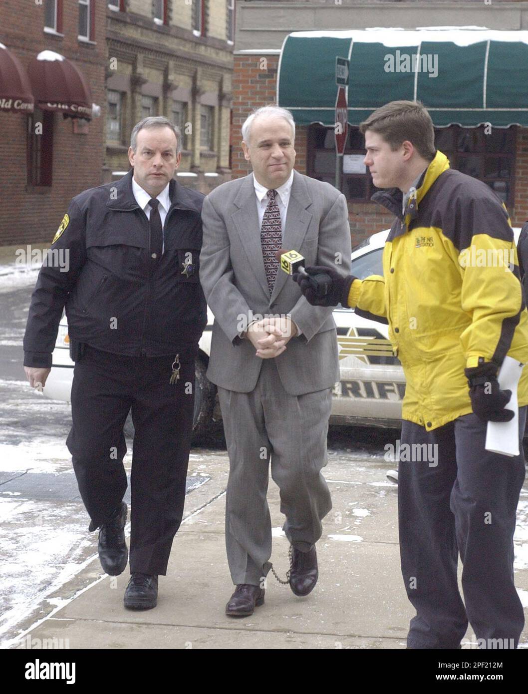 ** FILE ** A Lycoming County sheriff leads Dr. Richard Illes Sr. past a ...