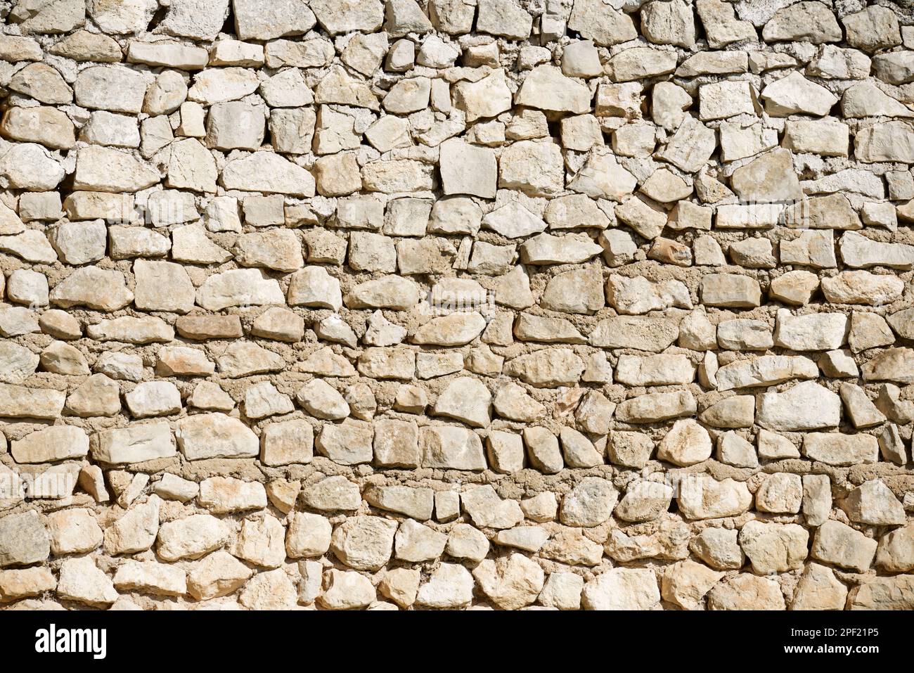 Texture of an old stone wall in Spain Stock Photo - Alamy
