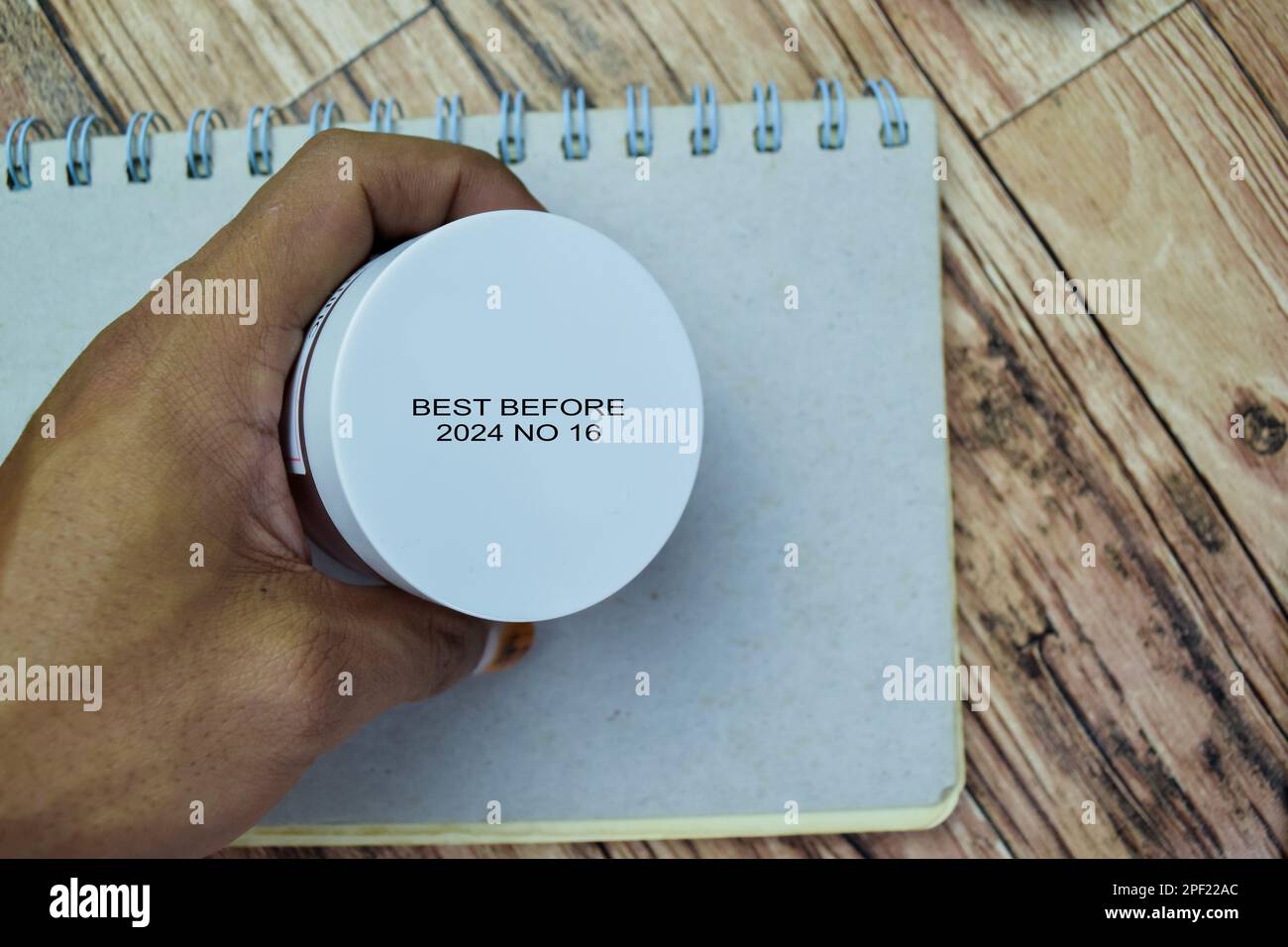 Concept of Best Before Date on Bottle Cap Food isolated on Wooden Table ...