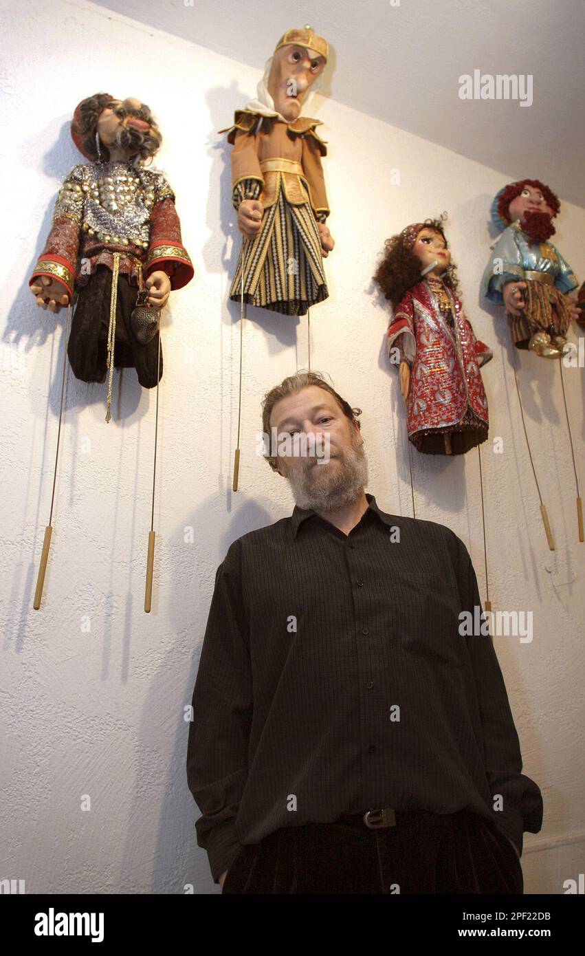 Igor Gozman, artistic director of PuppetArt, poses with puppets that ...