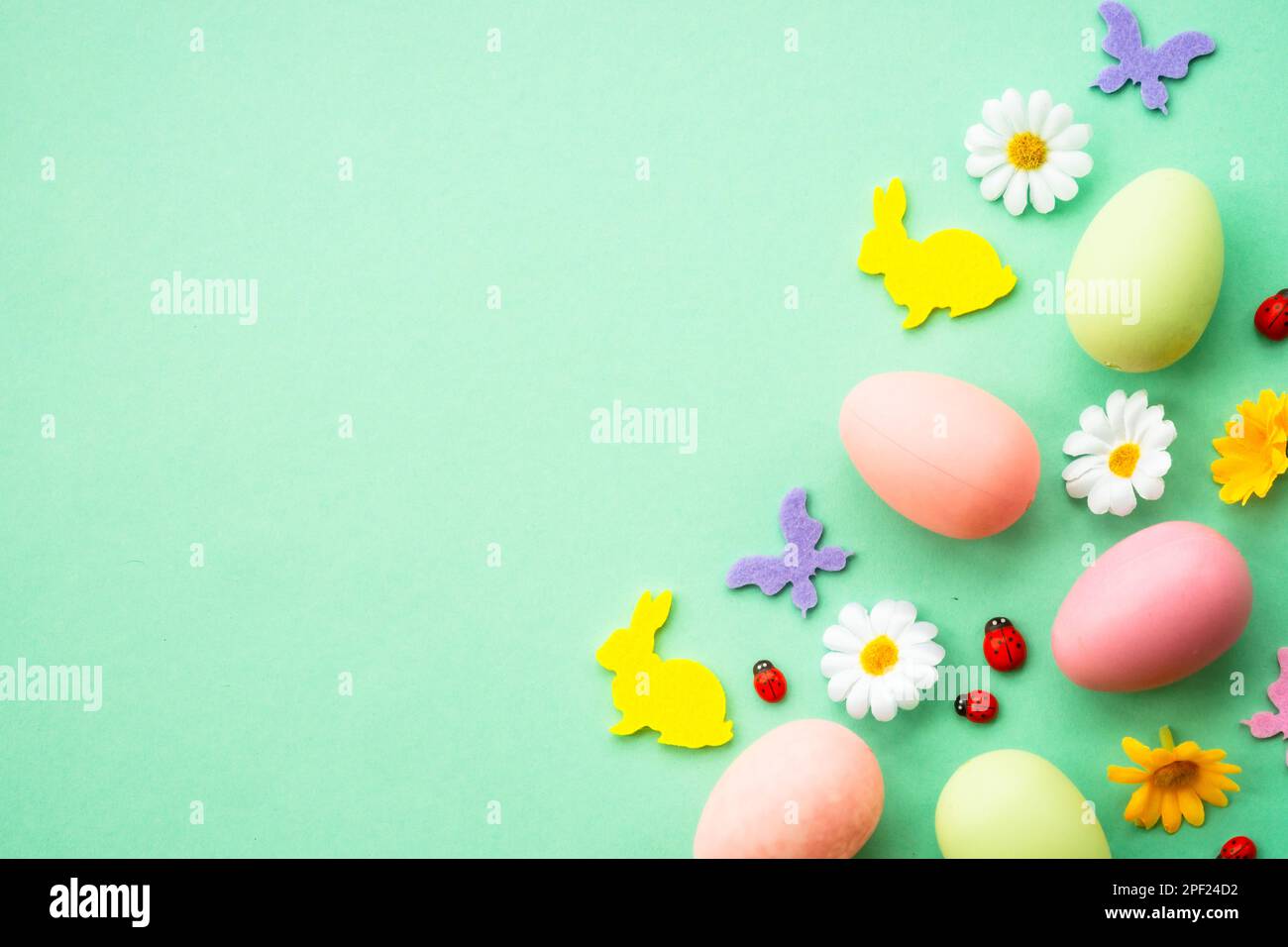 Easter background with Eggs, rabbit and spring flowers at green ...