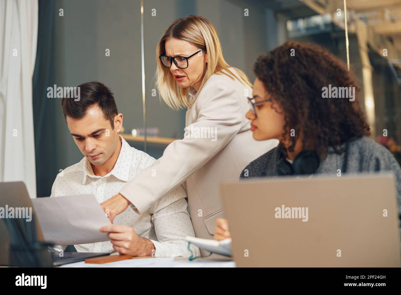 Business team is analysing new financial project while working together ...