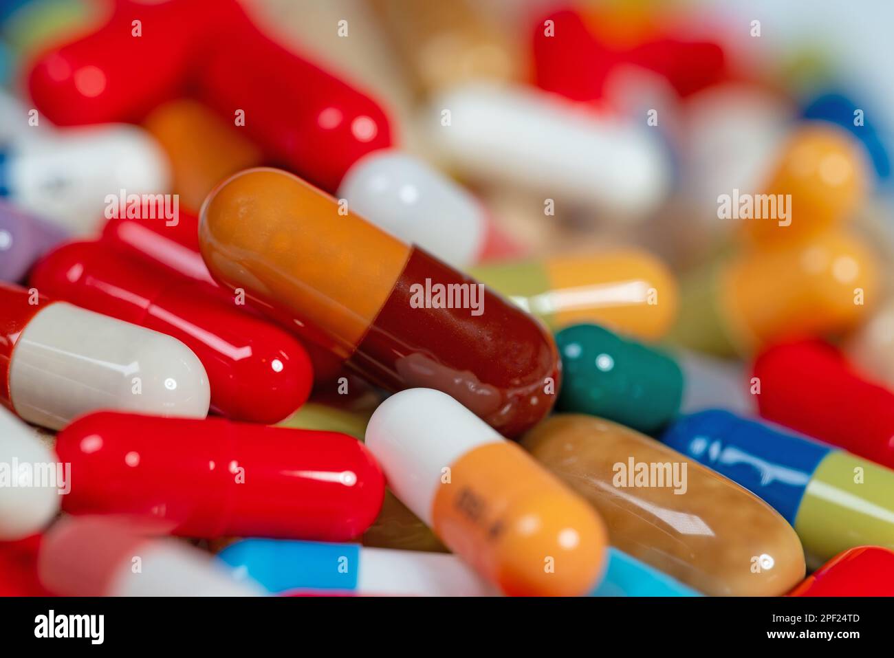 Many colorful capsules and tablets in a closeup Stock Photo - Alamy