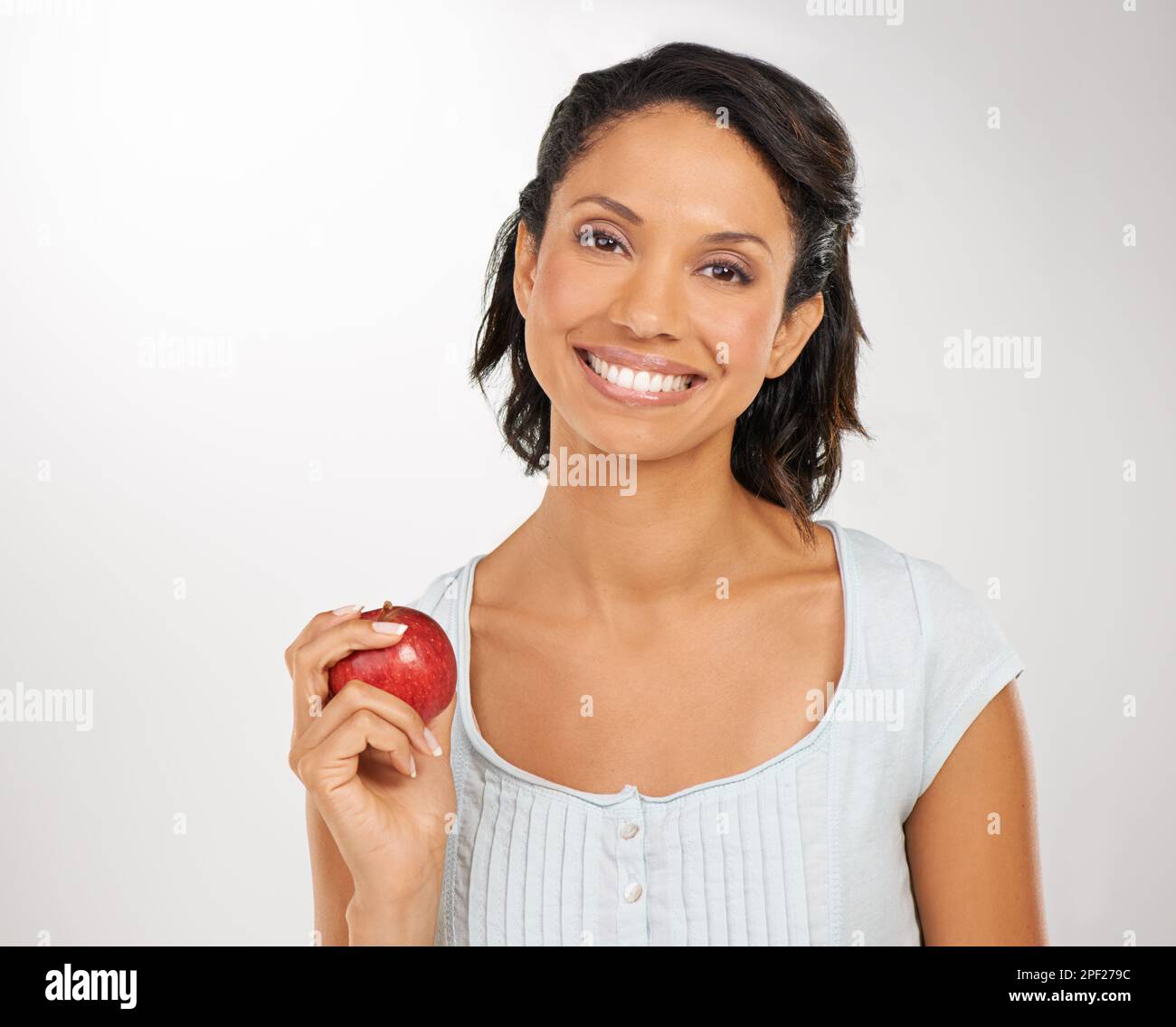 All about the apple. Portrait of a young woman enjoying a healthy snack ...