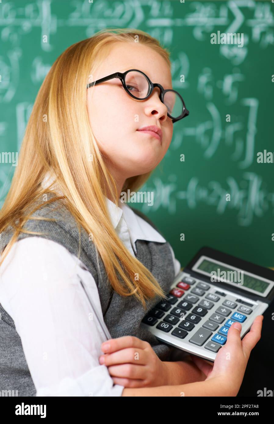 Confident she has the correct answer. Portrait of a cute blonde girl ...