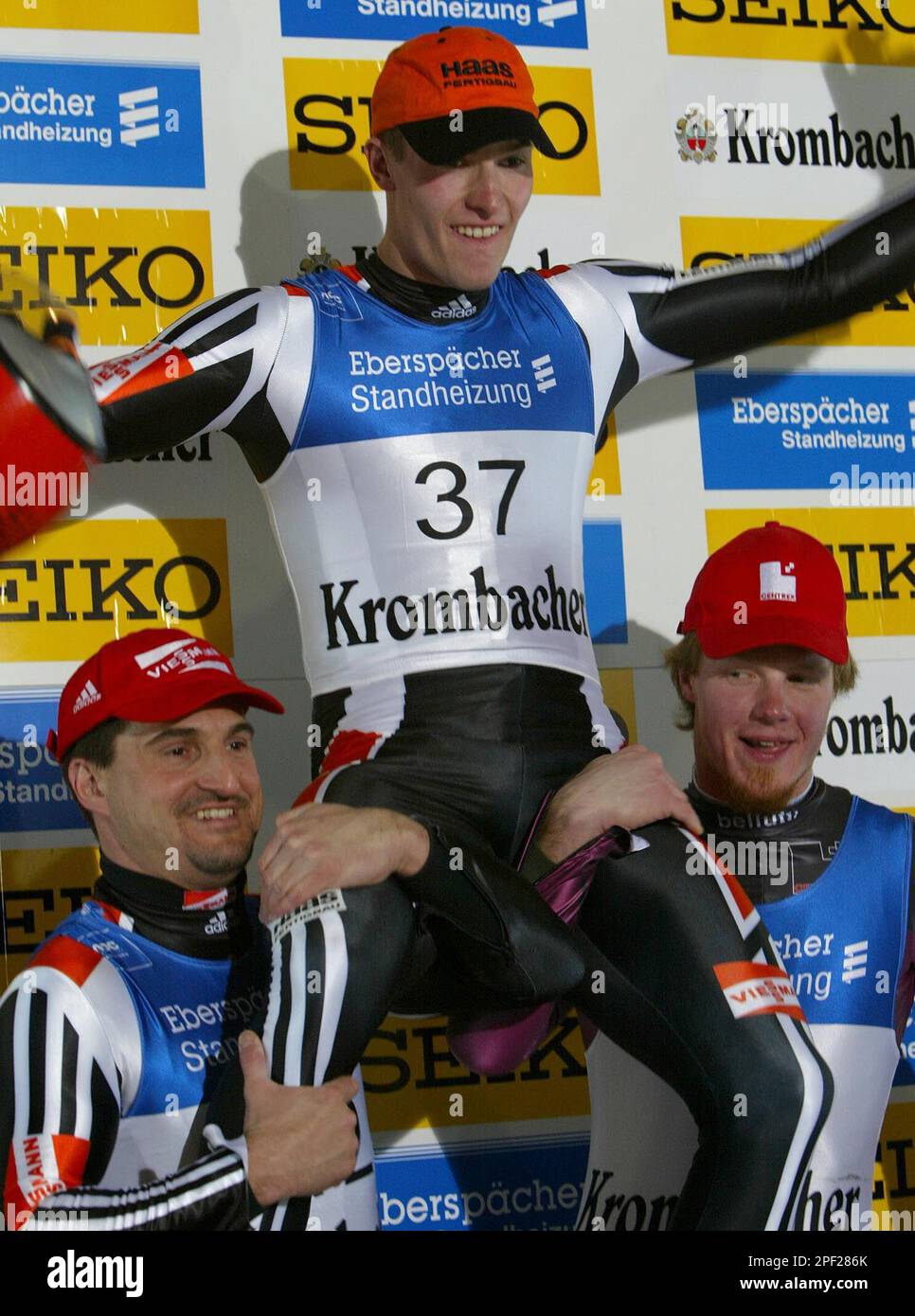 Men's singles winner David Moeller of Germany, center, is lifted up ...