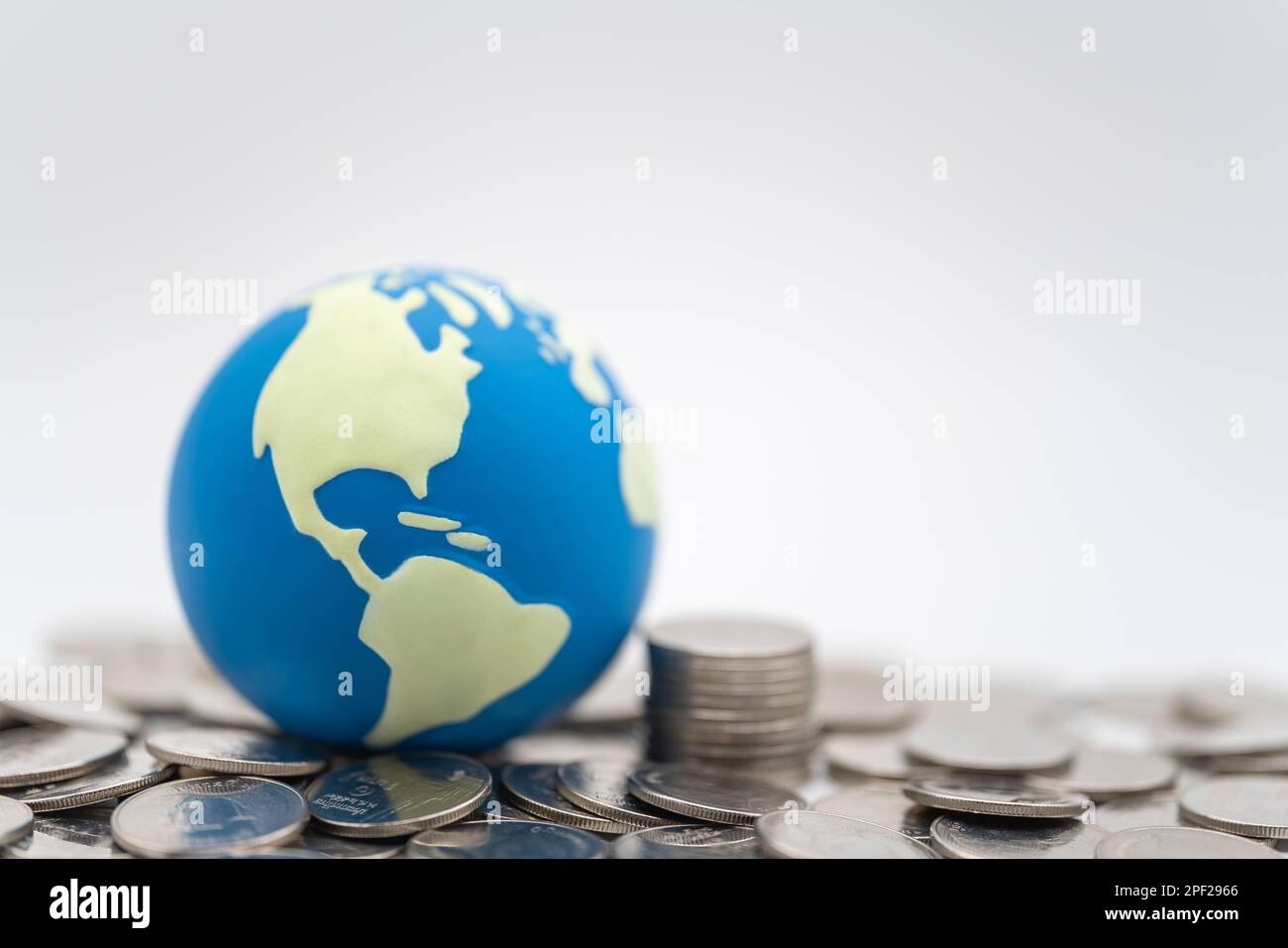 Money Global Business Concept. Closeup of mini world ball on pile and ...