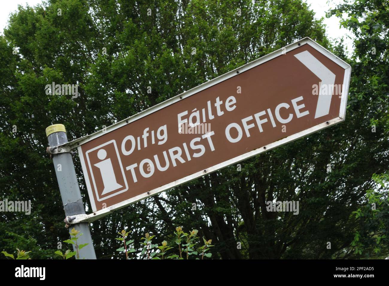bilingual road sign pointing to the tourist office in Adare, county ...