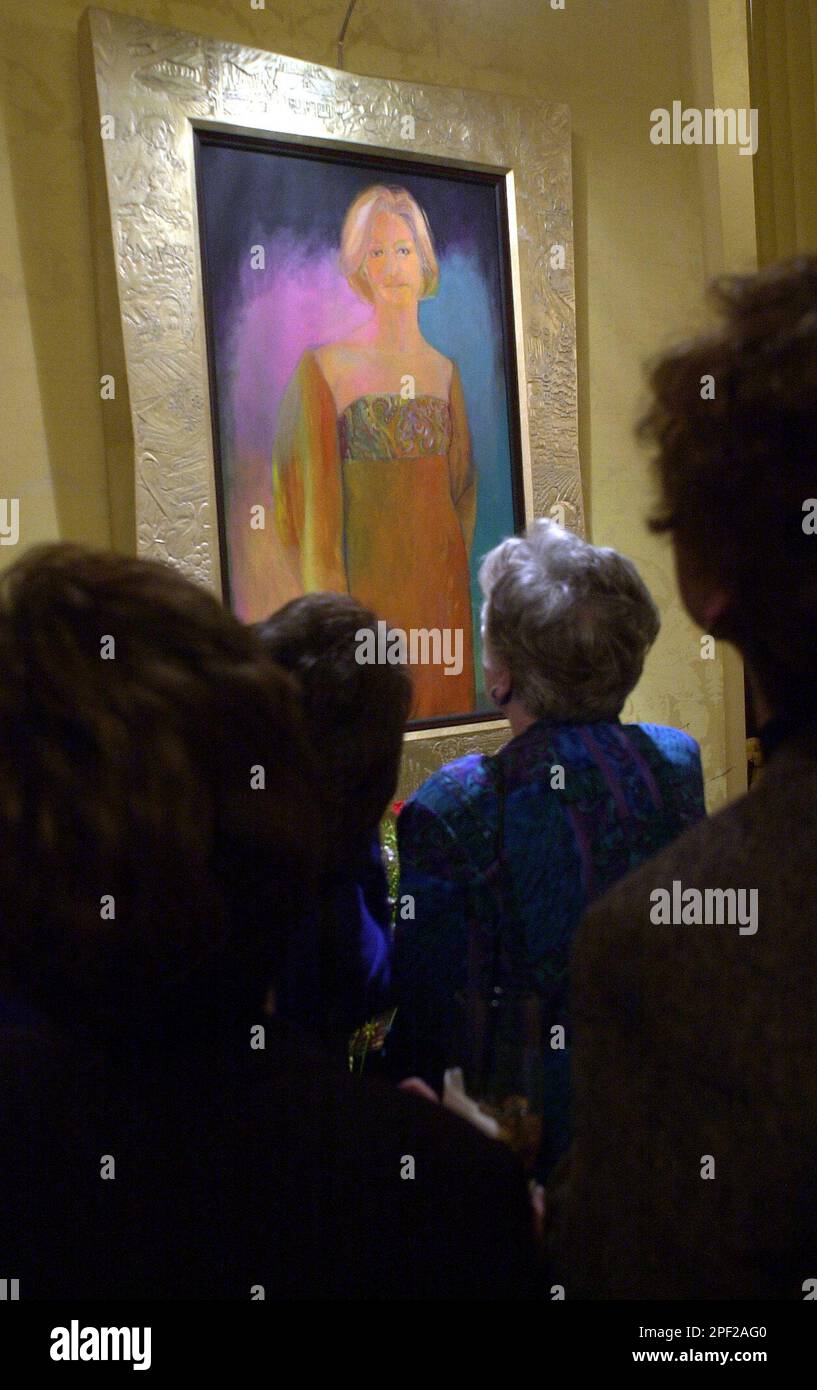 Guests at an unveiling ceremony look at the official portrait of ...