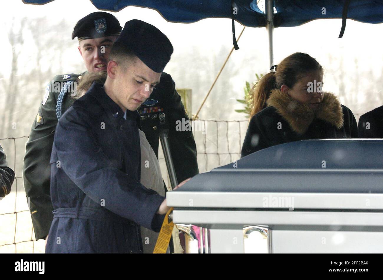 Airman Thomas Deckert touches the casket of his childhood friend Spc ...