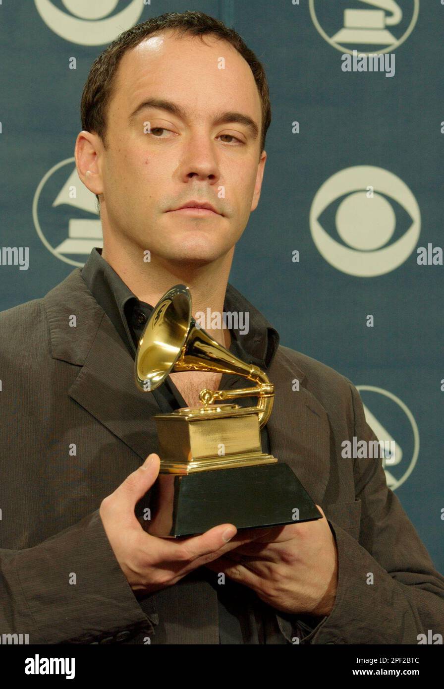 Dave Matthews holds the award he won for best male rock vocal ...