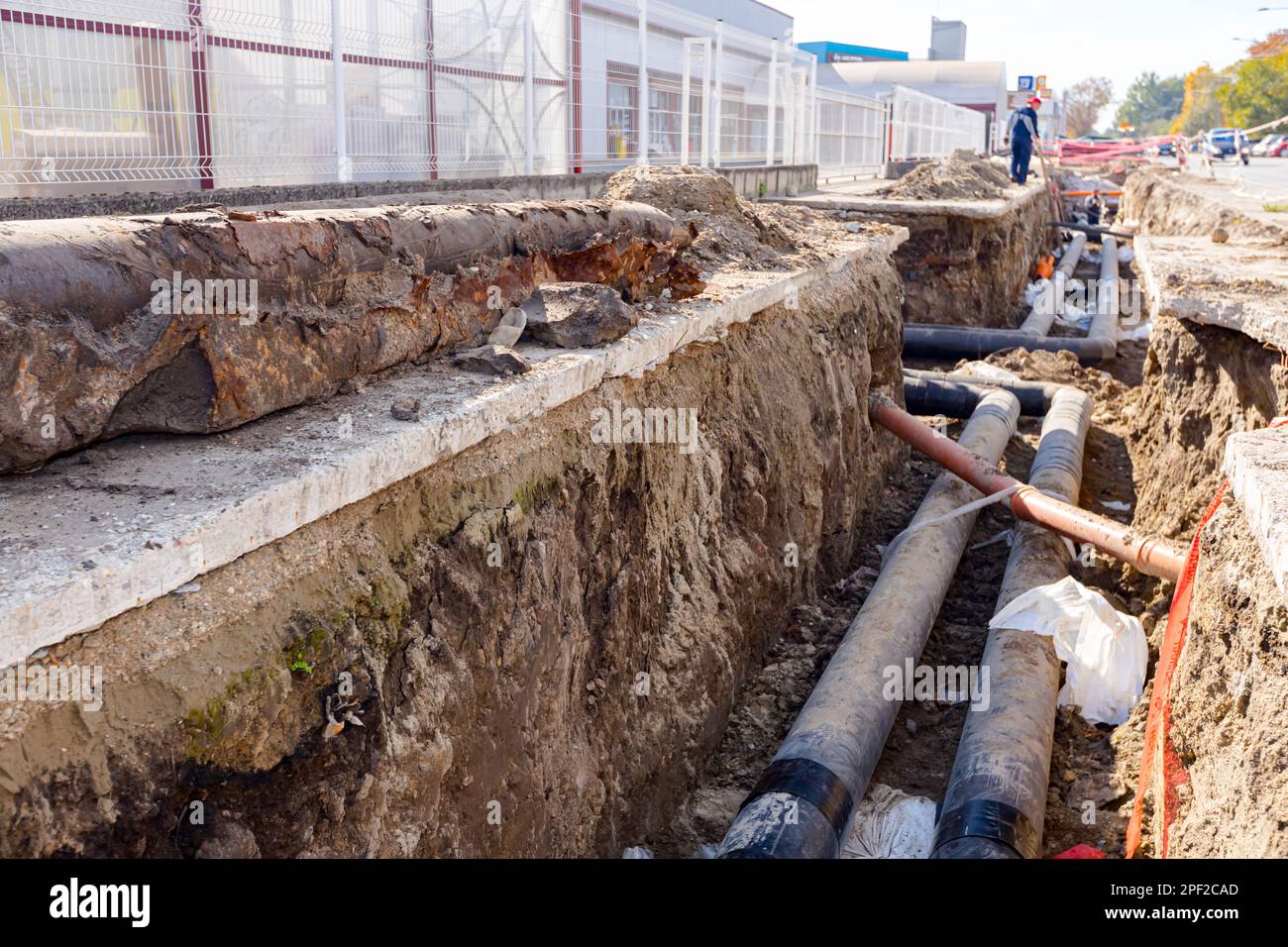 Old broken rusty rotten pipes are taken out from the trench and ...