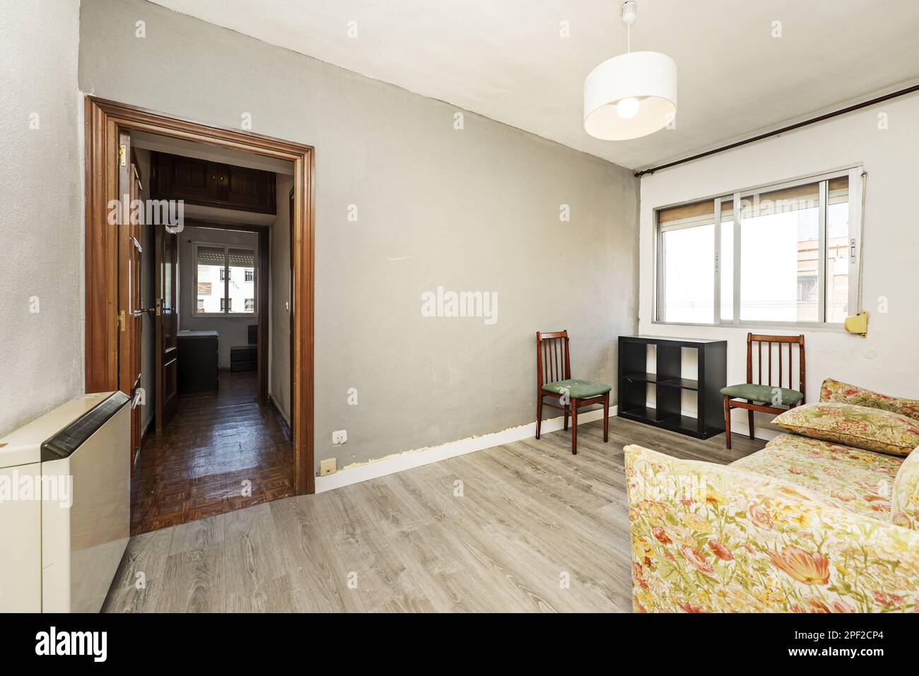 Living room furnished with a solitary sofa in a patterned fabric of ...