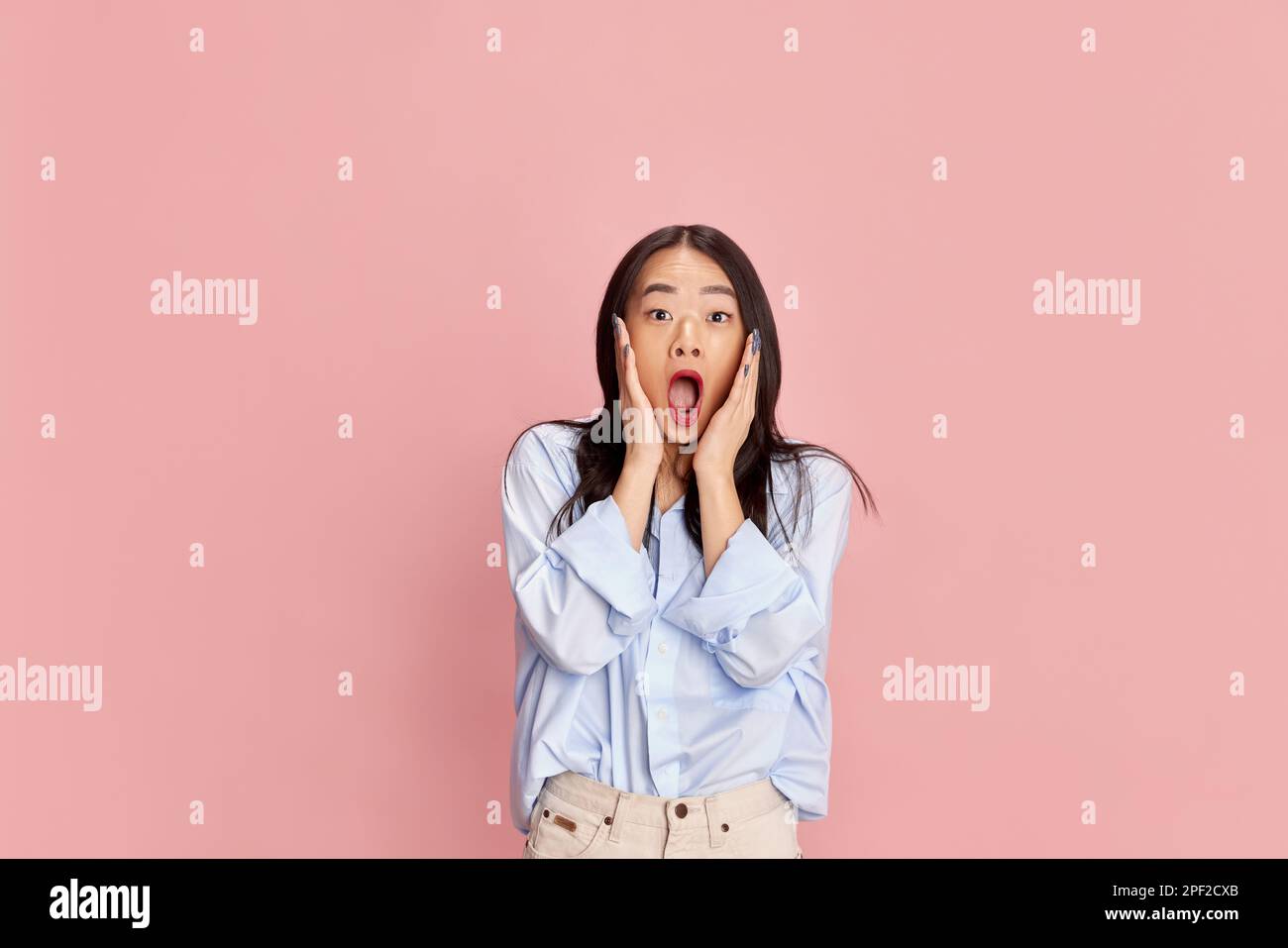 Surprise. Portrait of young beautiful girl in casual clothes posing ...