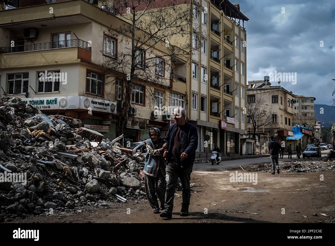Gaziantep, Turkey. 16th Mar, 2023. An elderly couple seen walking past the wreckage. One of the ...