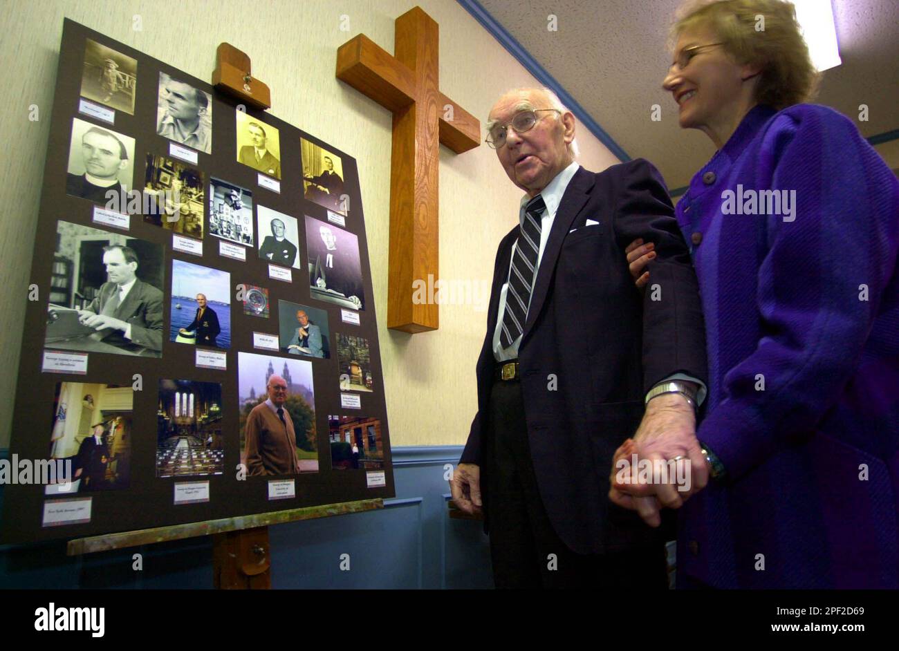 Rev. George M. Docherty and his wife, Sue, look at a display of photos ...