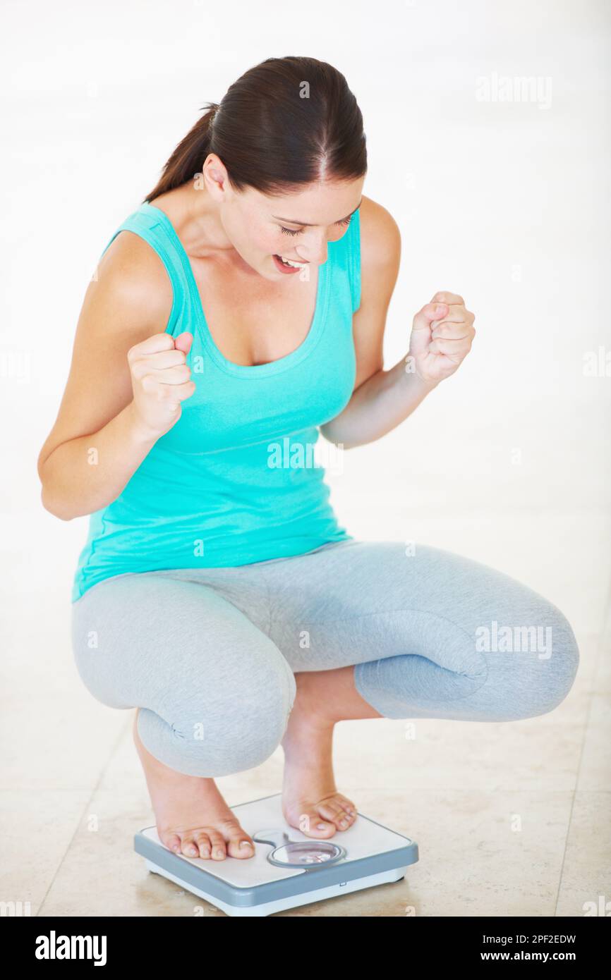 My diet is really paying off. A beautiful young woman cheering while ...