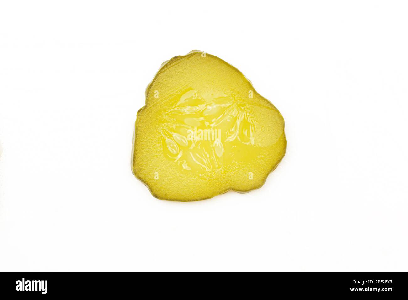Piece of sliced pickle isolated on white background. One shiny piece of ...