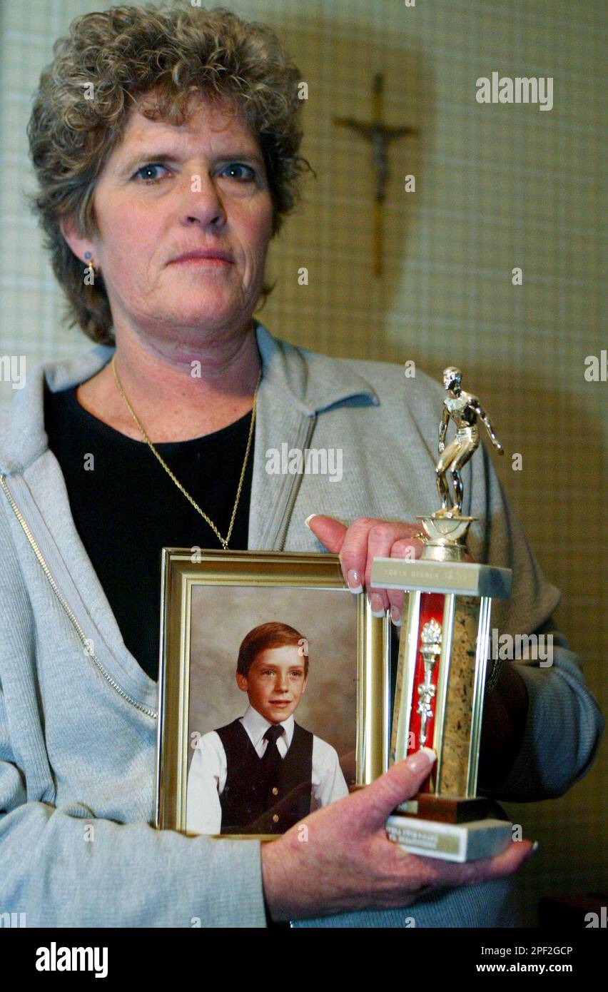 Mary Ann Hughes, poses with a photo of her late son Christopher, then ...