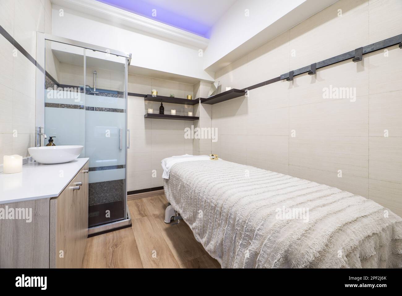 Cabin of a clinic for aesthetic treatments with a massage table and a ...