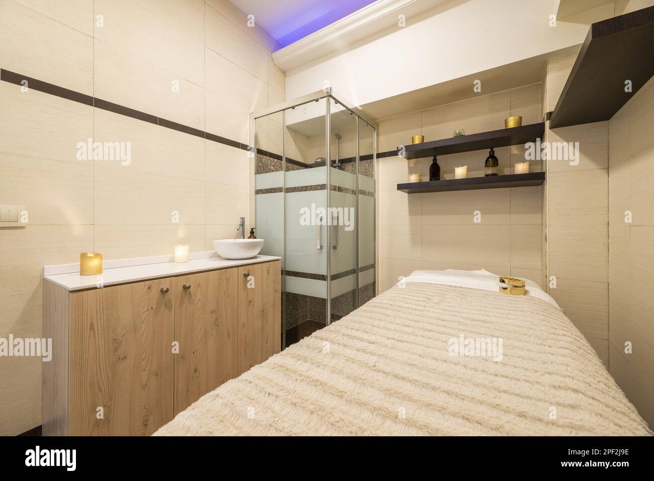 Cabin of a clinic for aesthetic treatments with massage table, shower ...