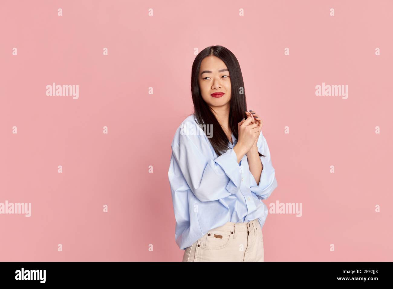 Portrait of young beautiful girl in casual clothes posing with calm ...