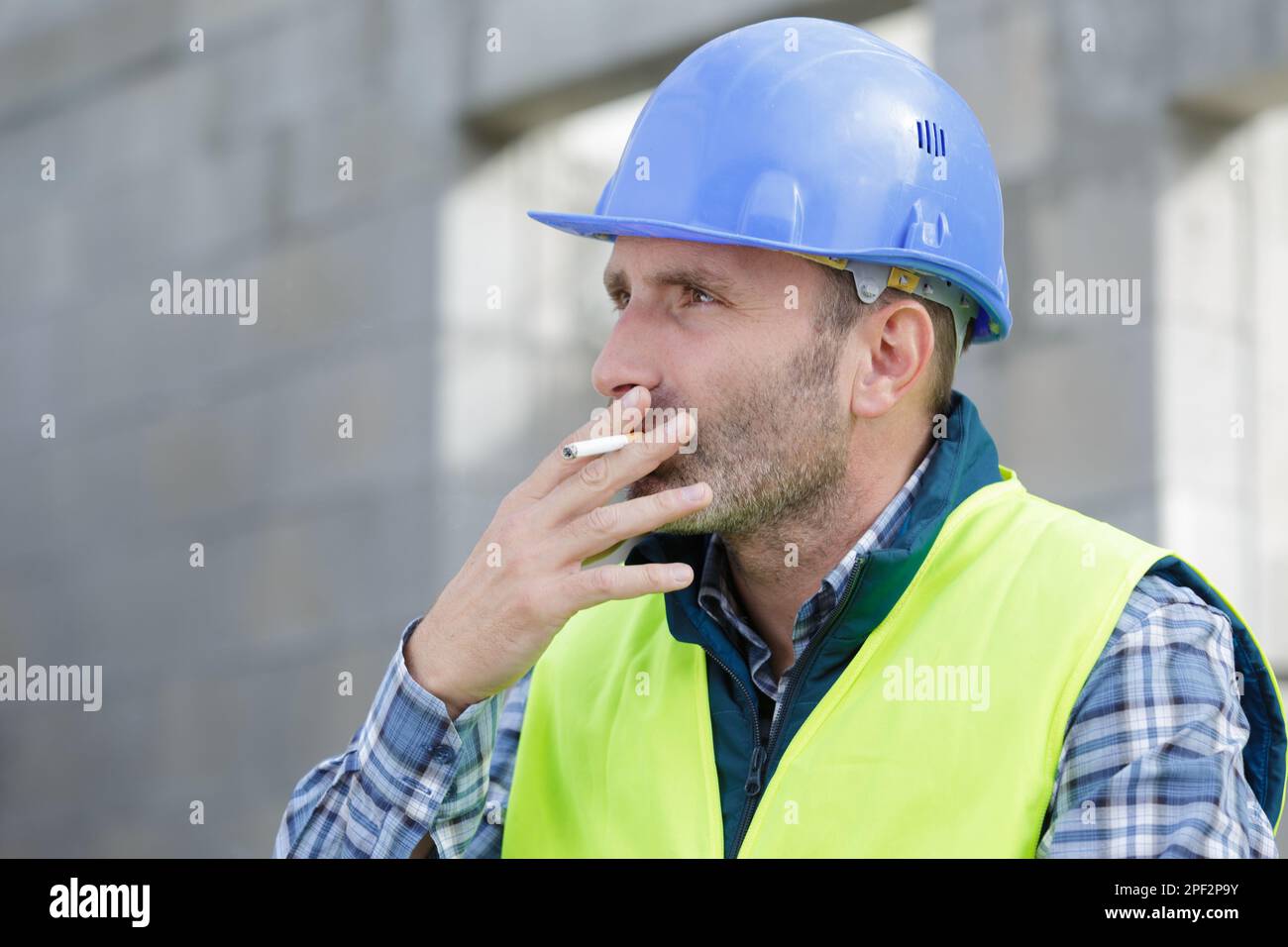 smoking cigarette on construction site Stock Photo - Alamy