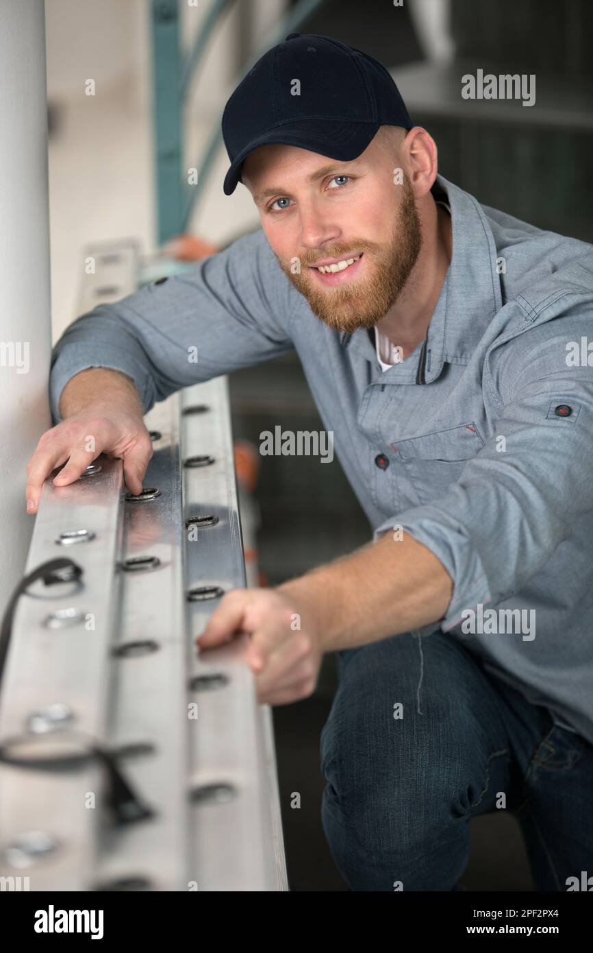 maintenance worker man holding aluminium step ladder Stock Photo - Alamy