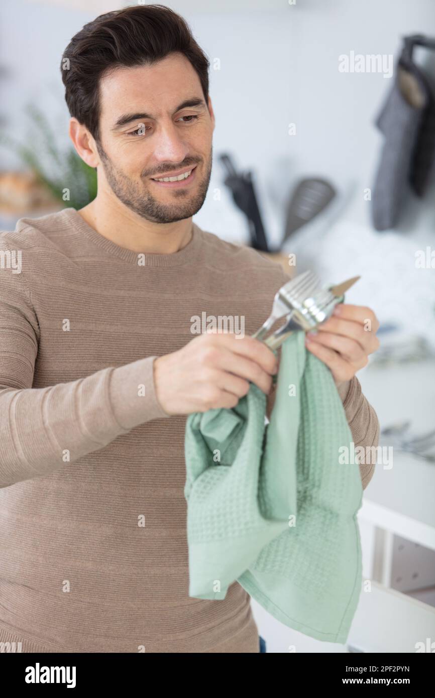 Man drying dishes hi-res stock photography and images - Alamy