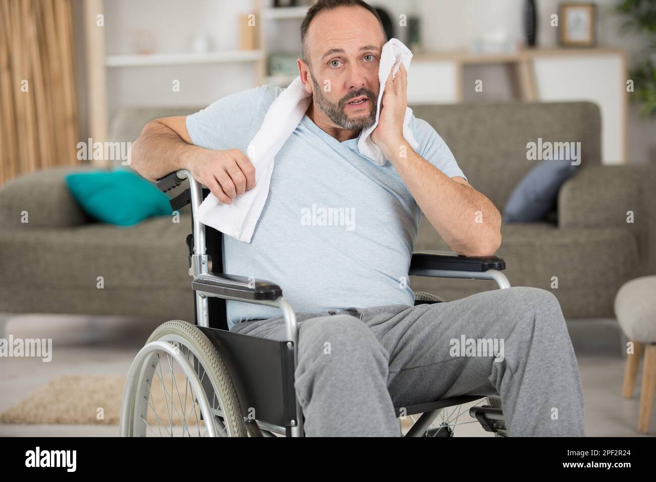disabled man wiping sweat from his brow after exercising Stock Photo ...