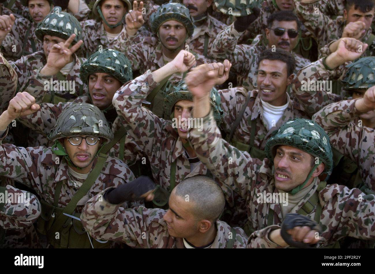 Members of the new Iraqi army chant together before being loaded onto ...