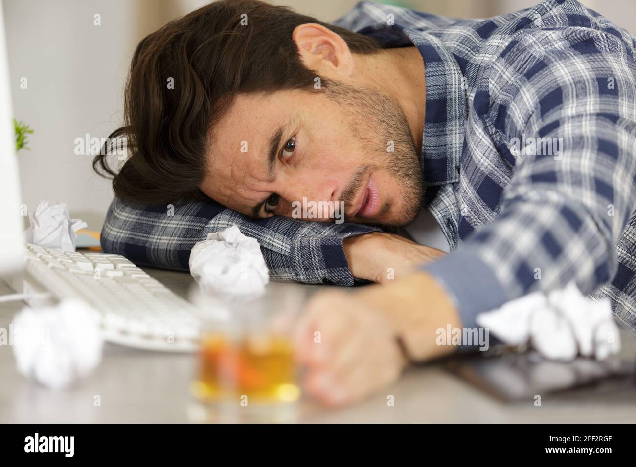 stressed office worker drunk while working Stock Photo - Alamy