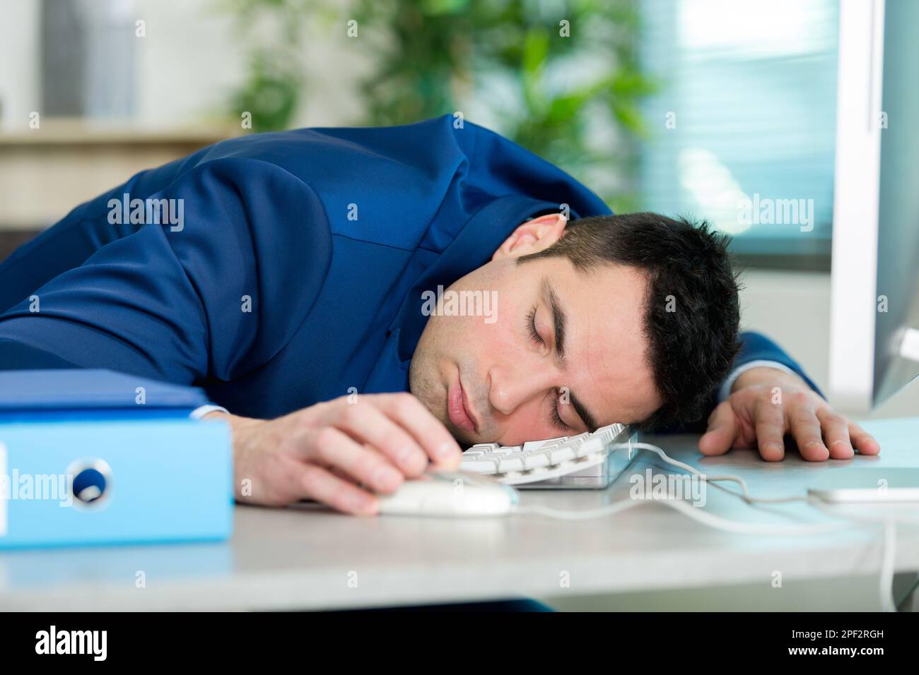tired office worker sleeping on top of keyboard Stock Photo - Alamy