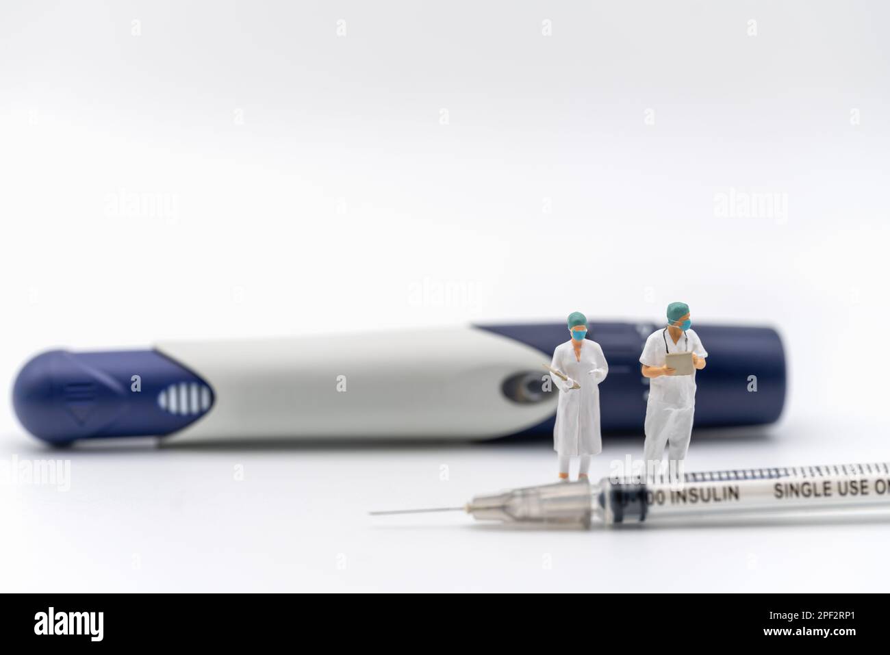 Doctor miniature figure with Patient file standing with lancet and ...
