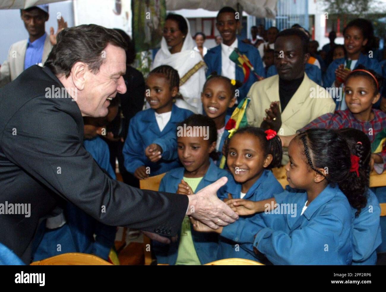 German Chancellor Gerhard Schroeder reaches out to shake hands with ...