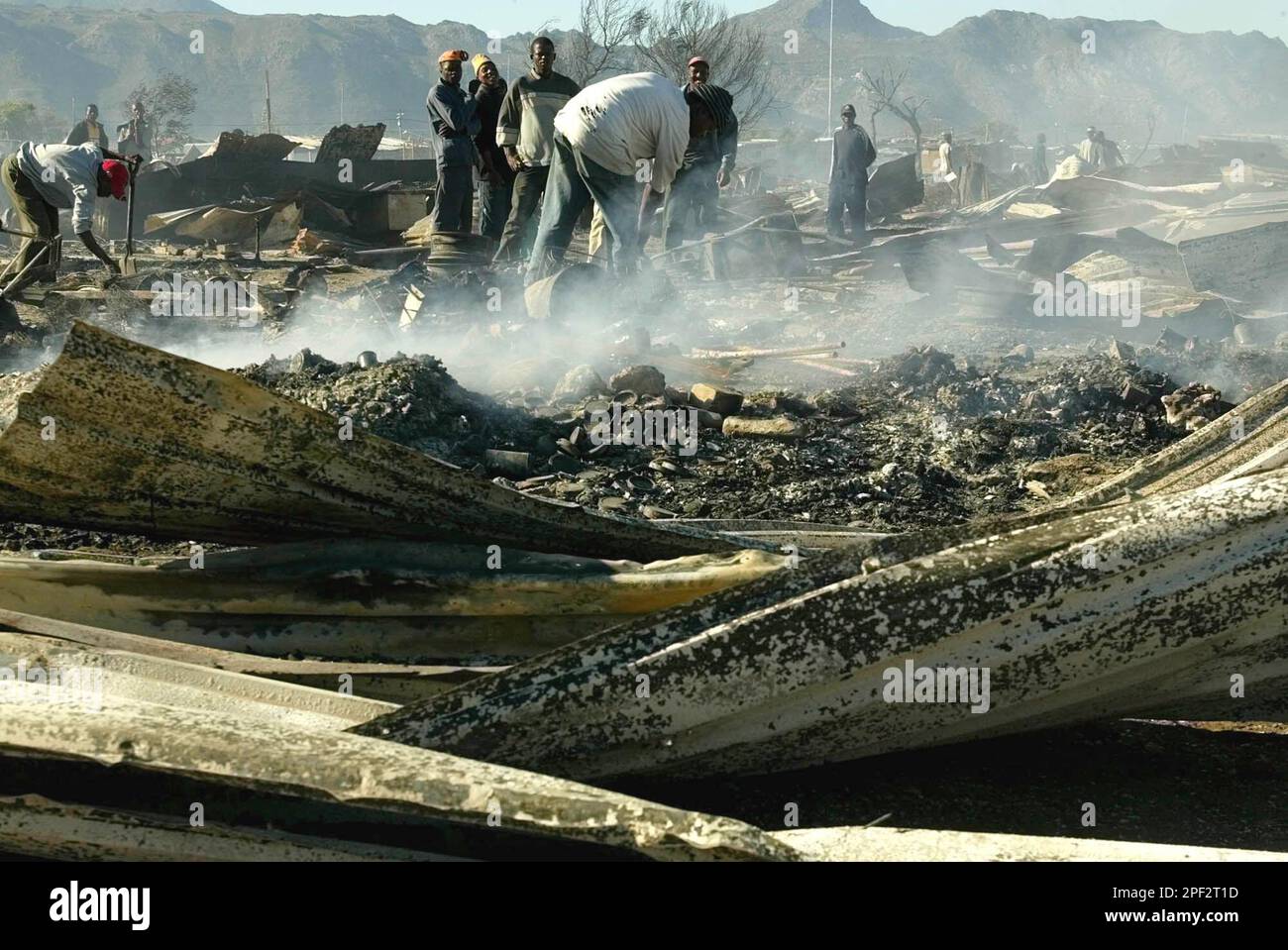Residents of Nomzamo informal settlement search among fire debris for ...