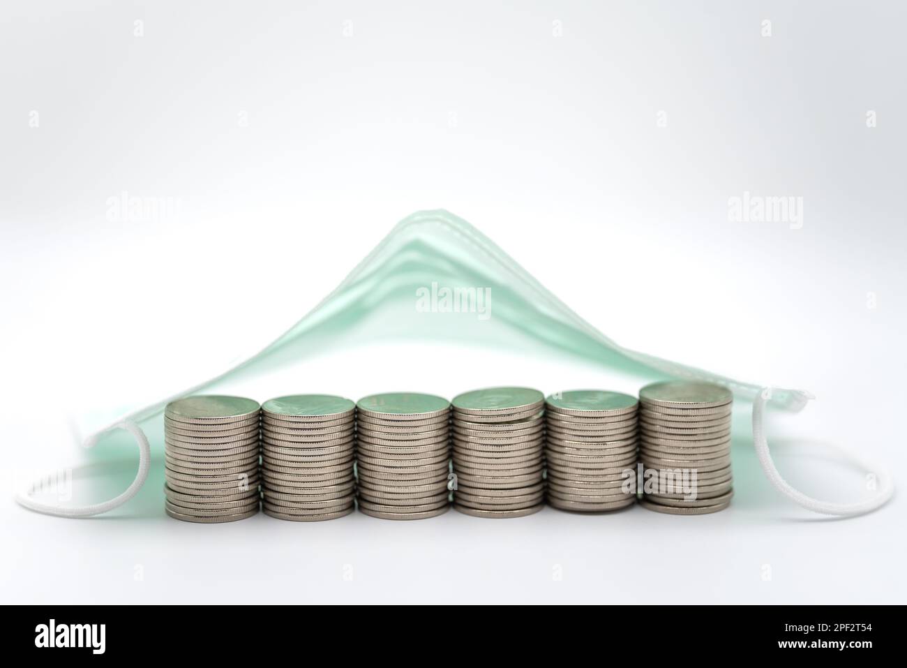 Money, Covid-19 and Healthcare Concept. Closeup of stack of silver ...